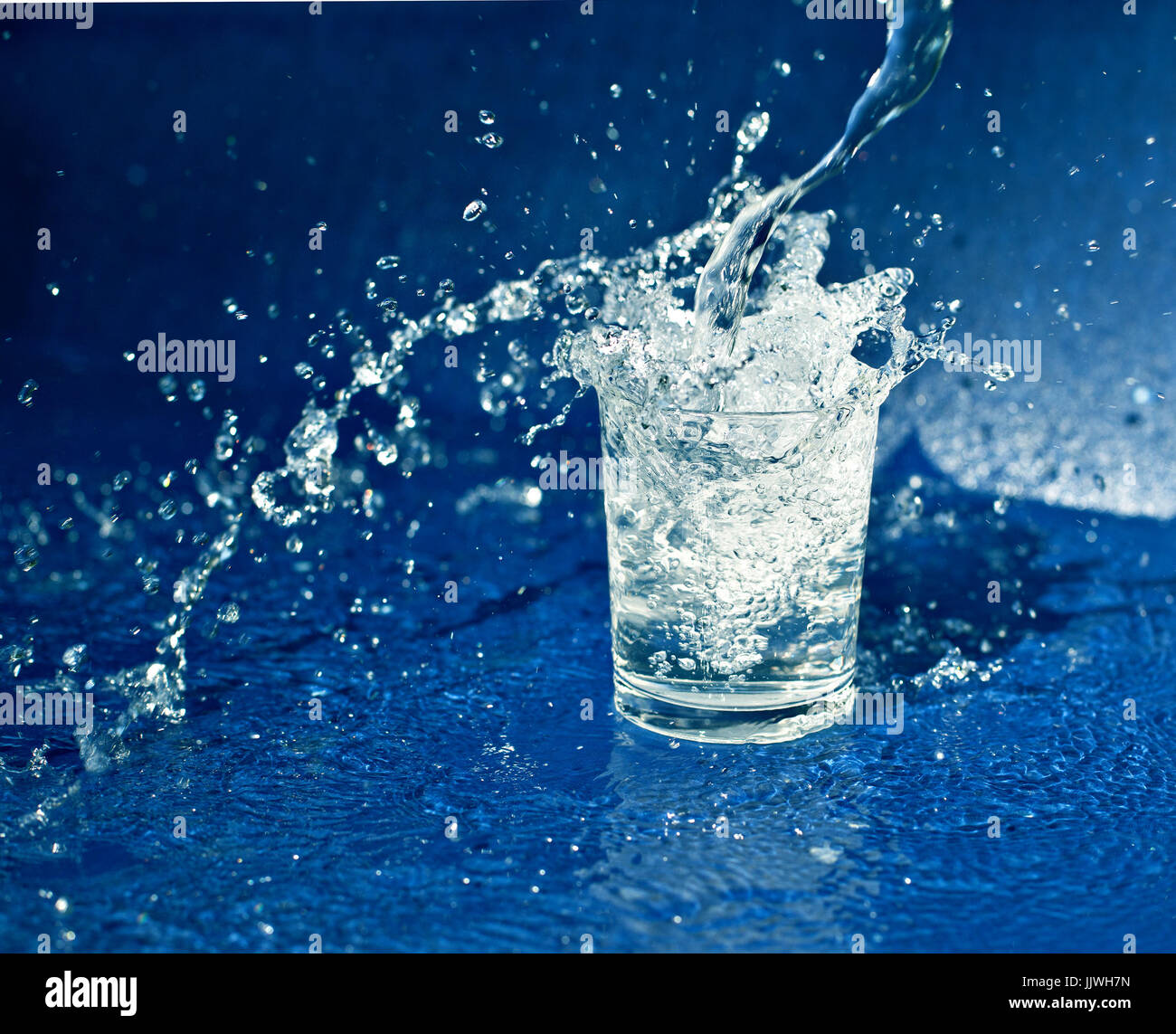 Splashing water from glass Stock Photo - Alamy