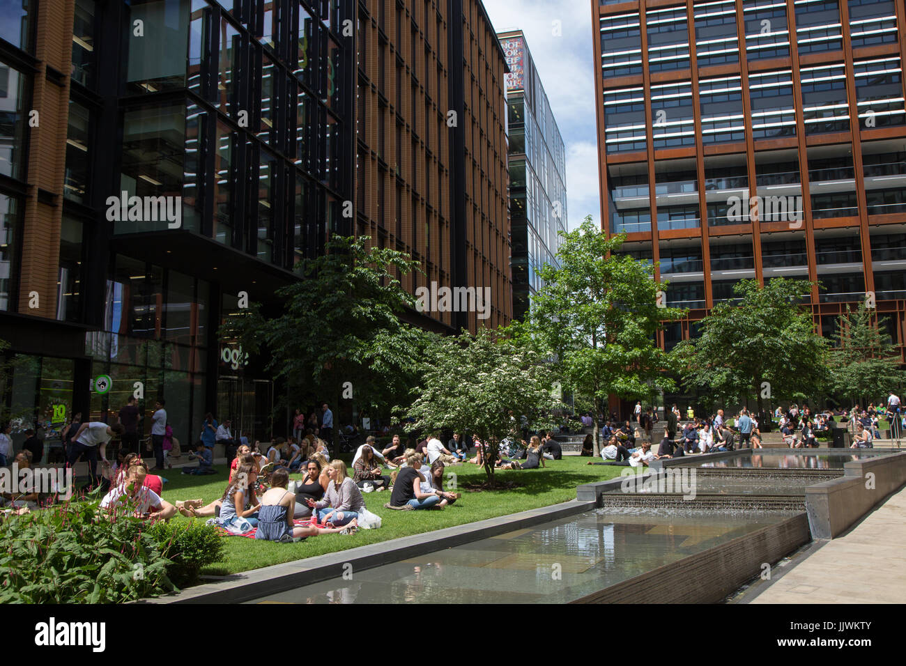 Employees from offices spill out for lunch on grass at Battle Bridge ...