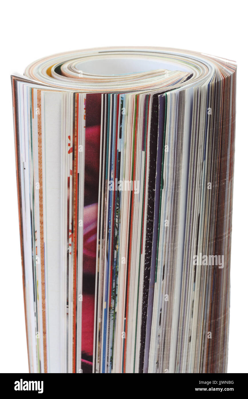 Rolled up magazine on bright background Stock Photo - Alamy