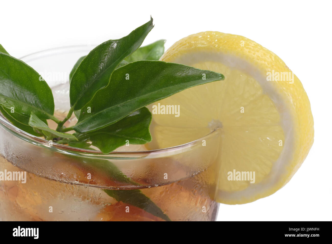 A glass full of Ice Tea with a lemon slice on bright background Stock ...