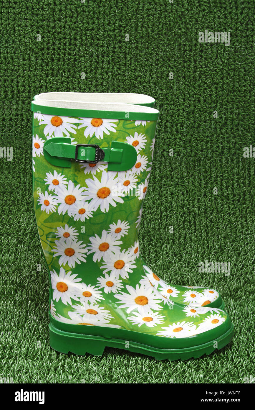 Colorful rubber boots on green grass backround Stock Photo - Alamy