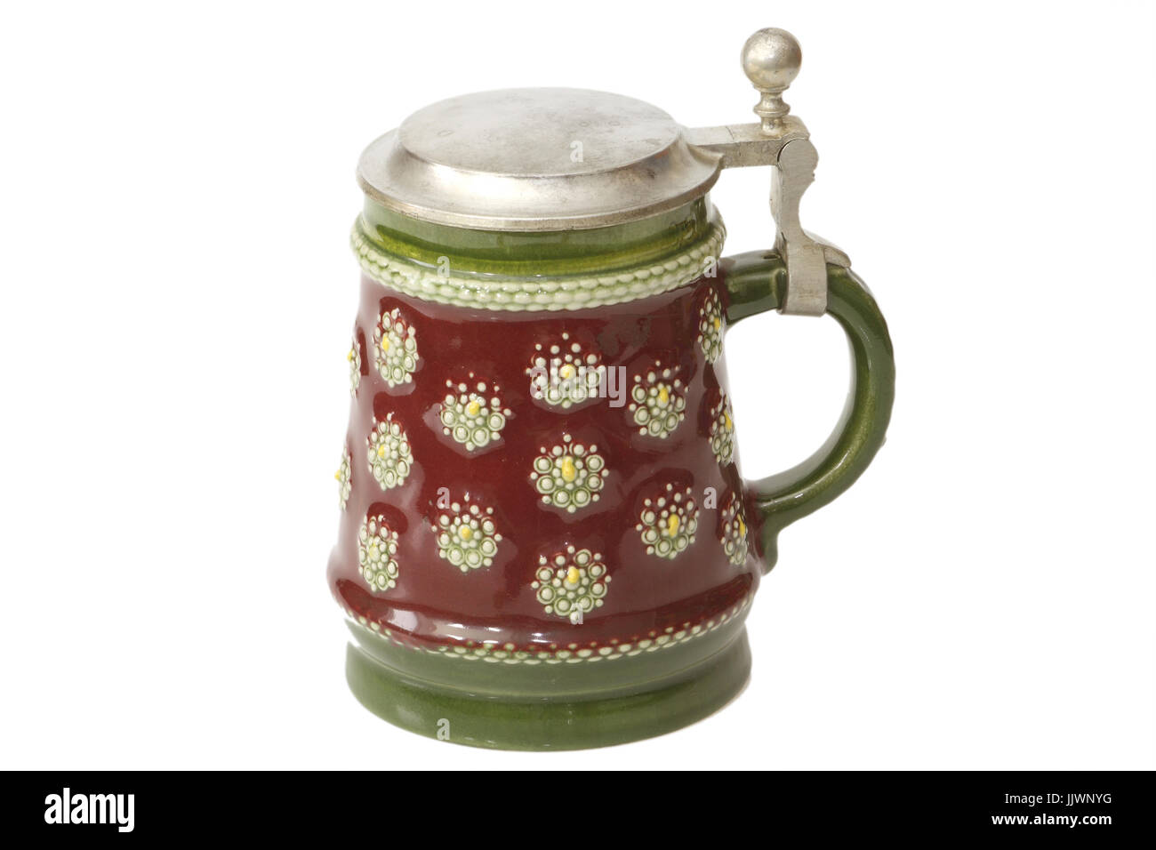 A traditional German beer jug with silver lid isolated on white ...