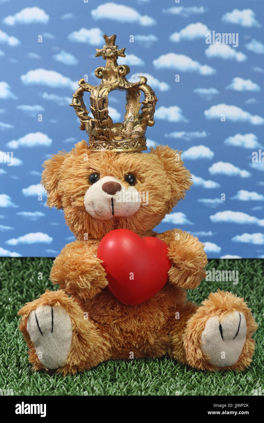Teddy bear with a crown and red heart. Shot in studio Stock Photo - Alamy
