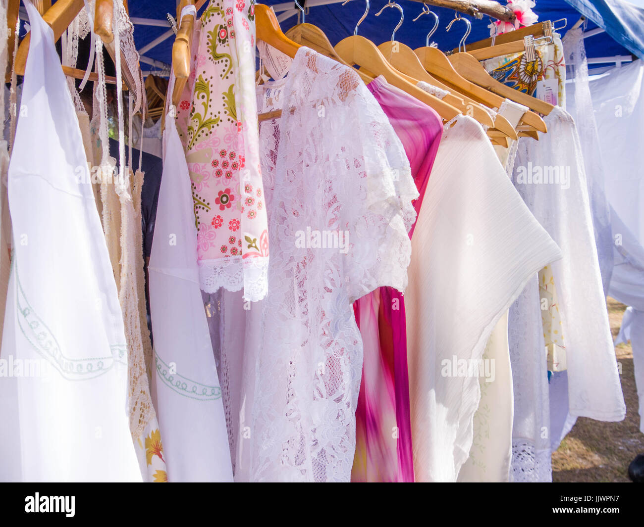 Vintage Women's dresses hanging on a Clothes Rack at a Market Stall ...