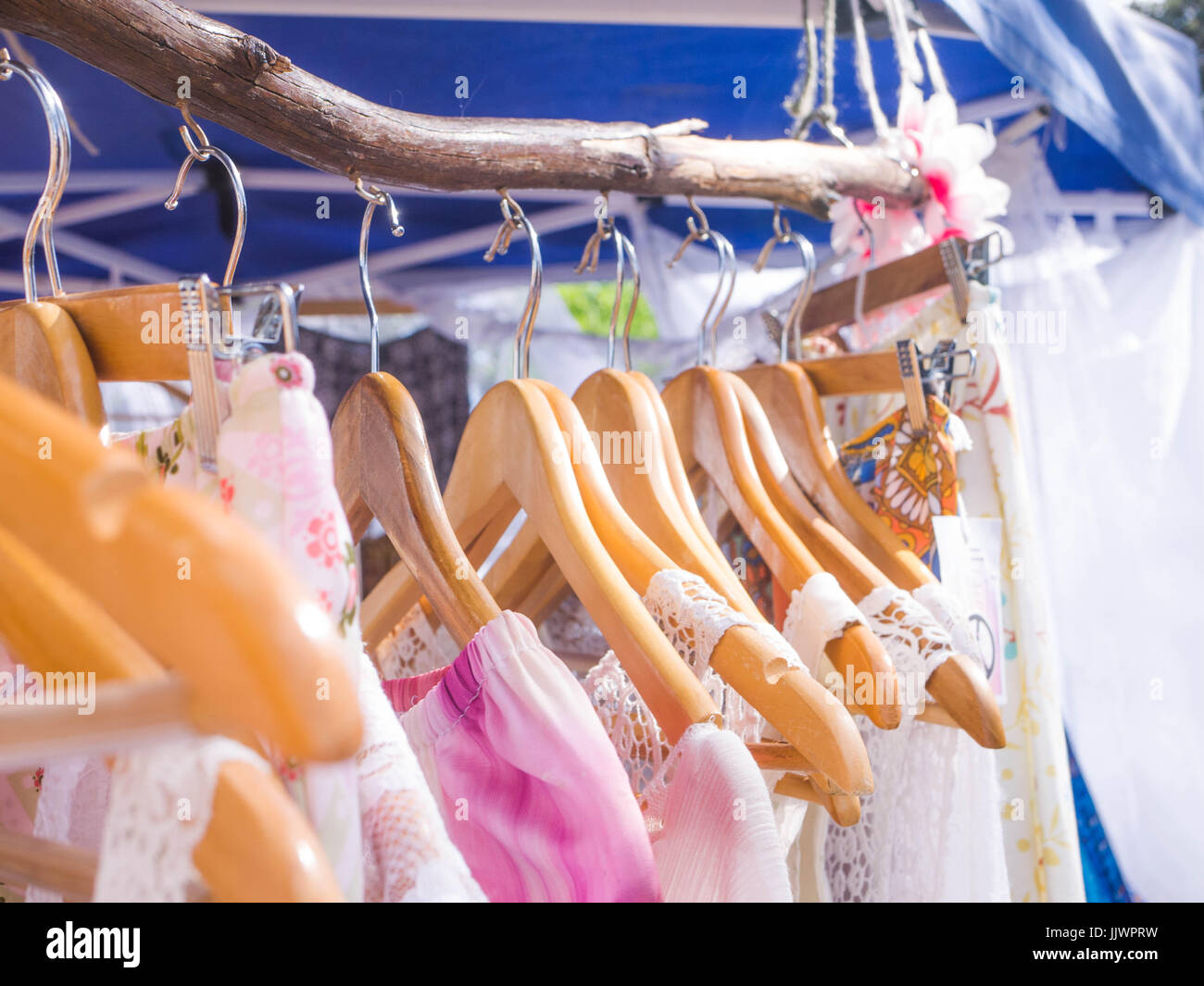 Vintage Women's dresses hanging on a Clothes Rack at a Market Stall ...