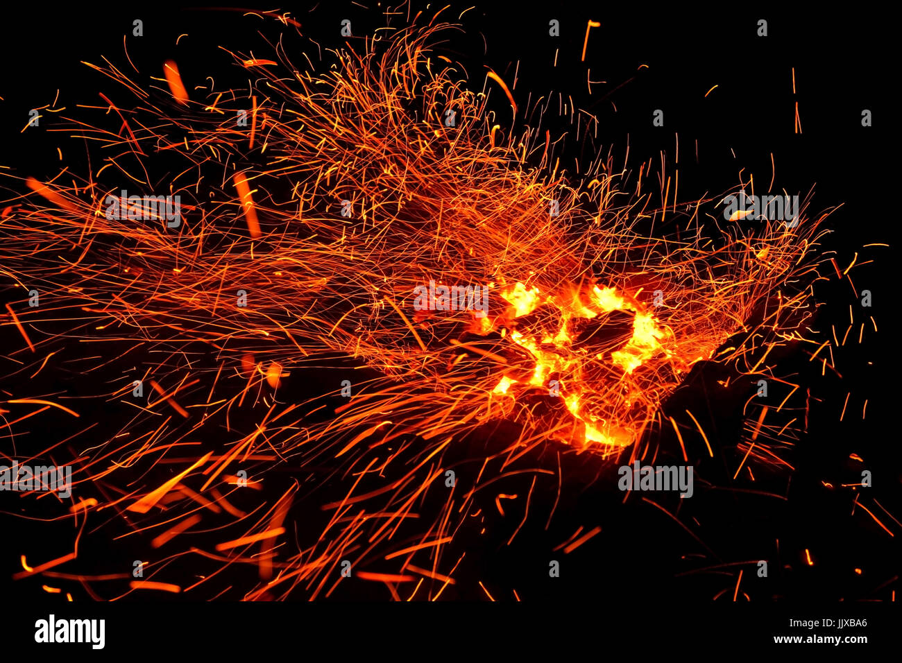 Hot sparking live-coals burning in a barbecue Stock Photo - Alamy