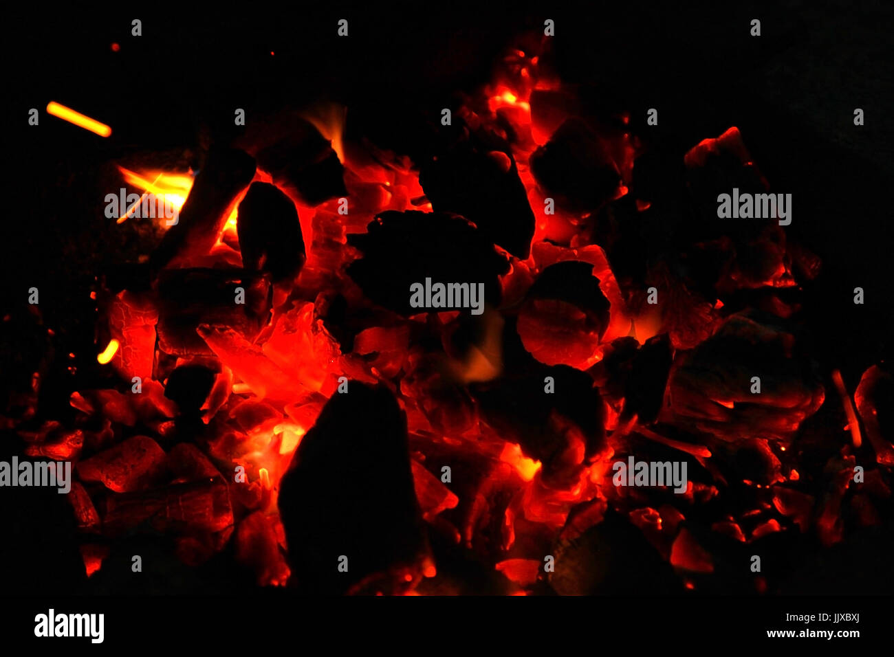 Hot sparking live-coals burning in a barbecue Stock Photo - Alamy