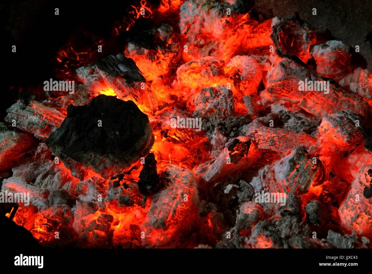Hot sparking live-coals burning in a barbecue Stock Photo - Alamy
