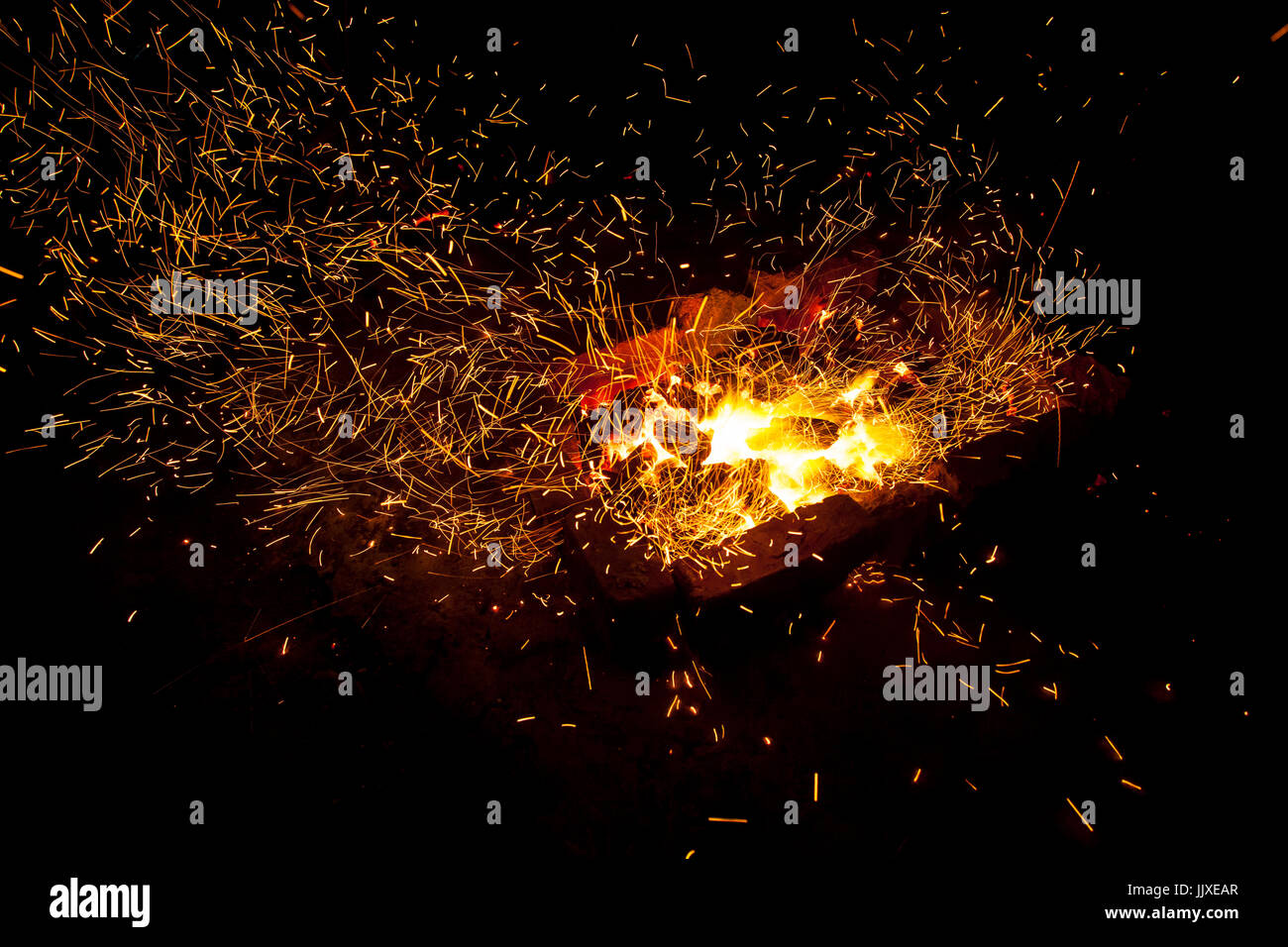 Hot sparking live-coals burning in a barbecue Stock Photo - Alamy