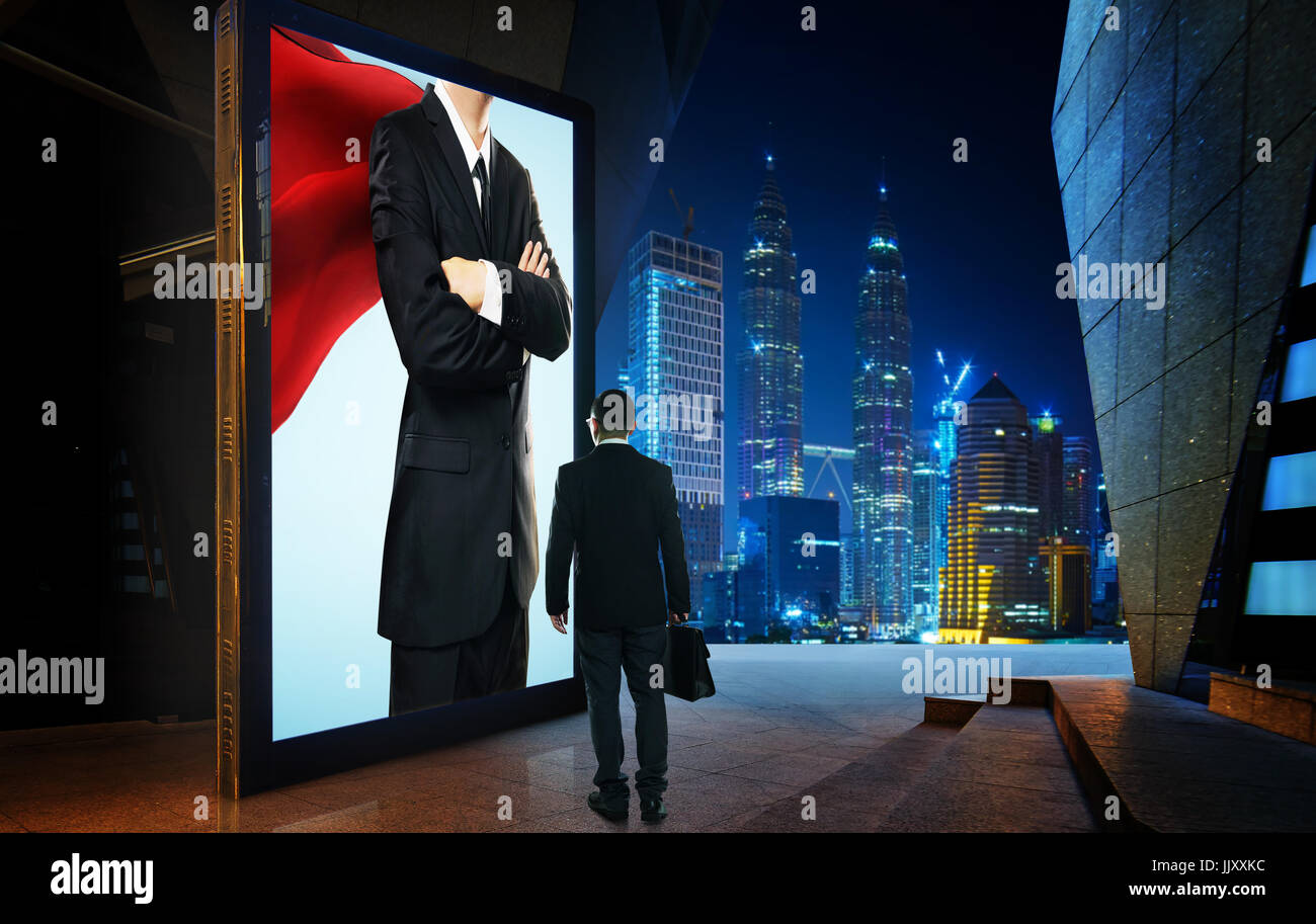 Young businessman looking the hero businessman on the advertising ...