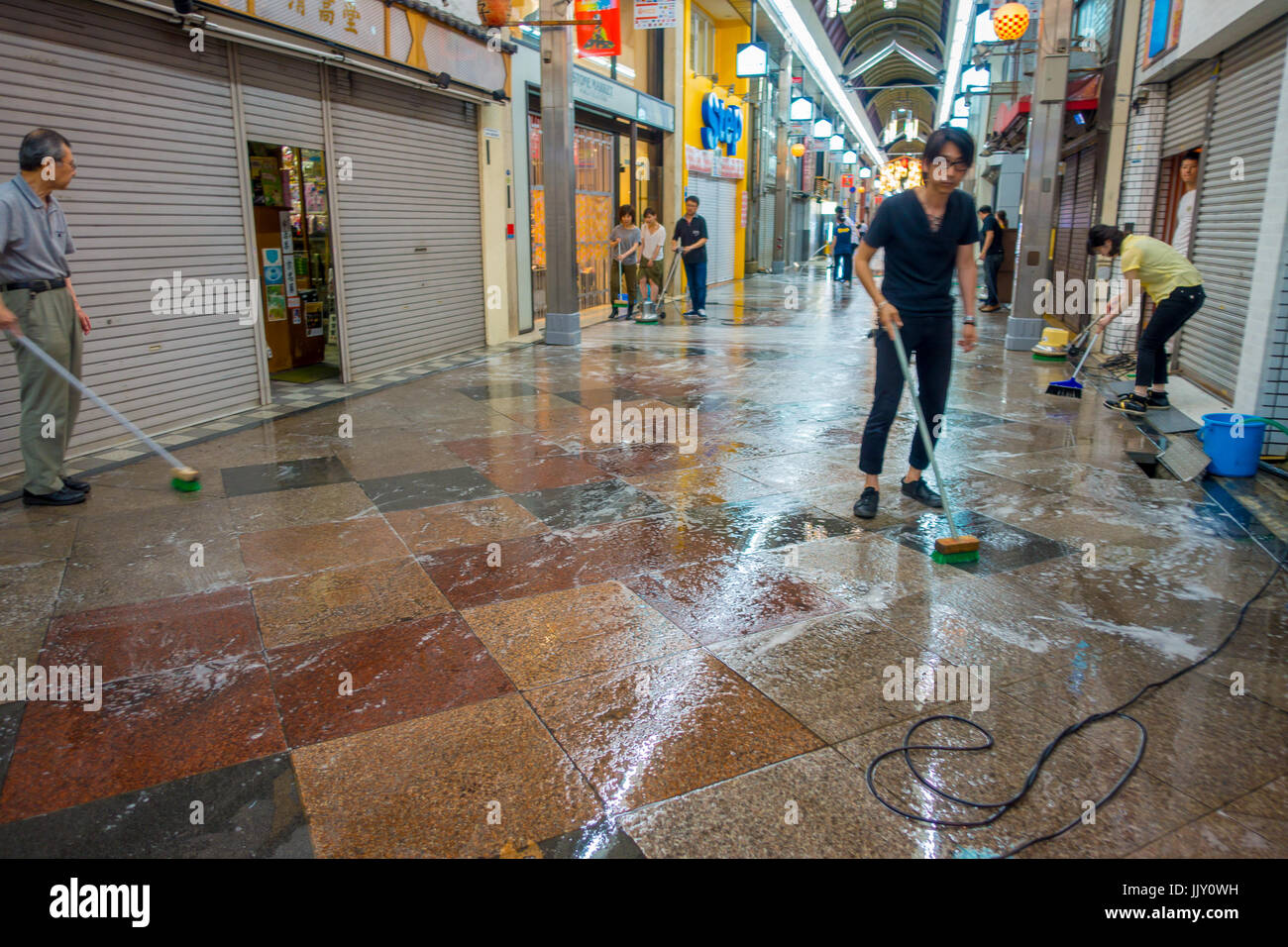 KYOTO, JAPAN - JULY 05, 2017: Unidentified people cleaning with brooms ...