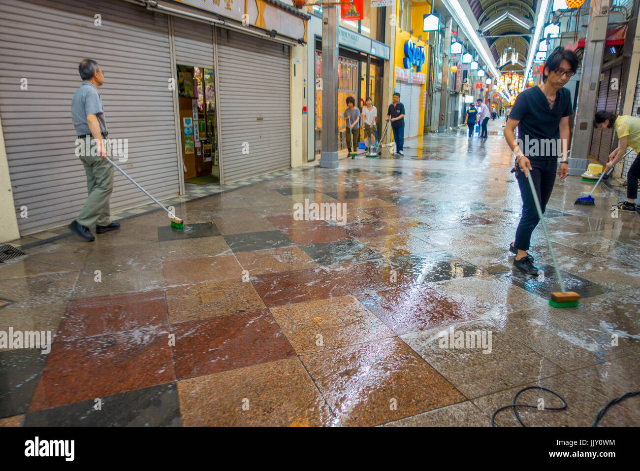 People cleaning street japan hi-res stock photography and images - Alamy