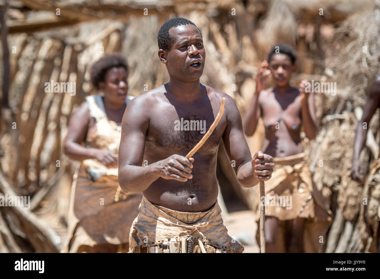 Men and women of the Damaraland tribe are performing traditional songs ...