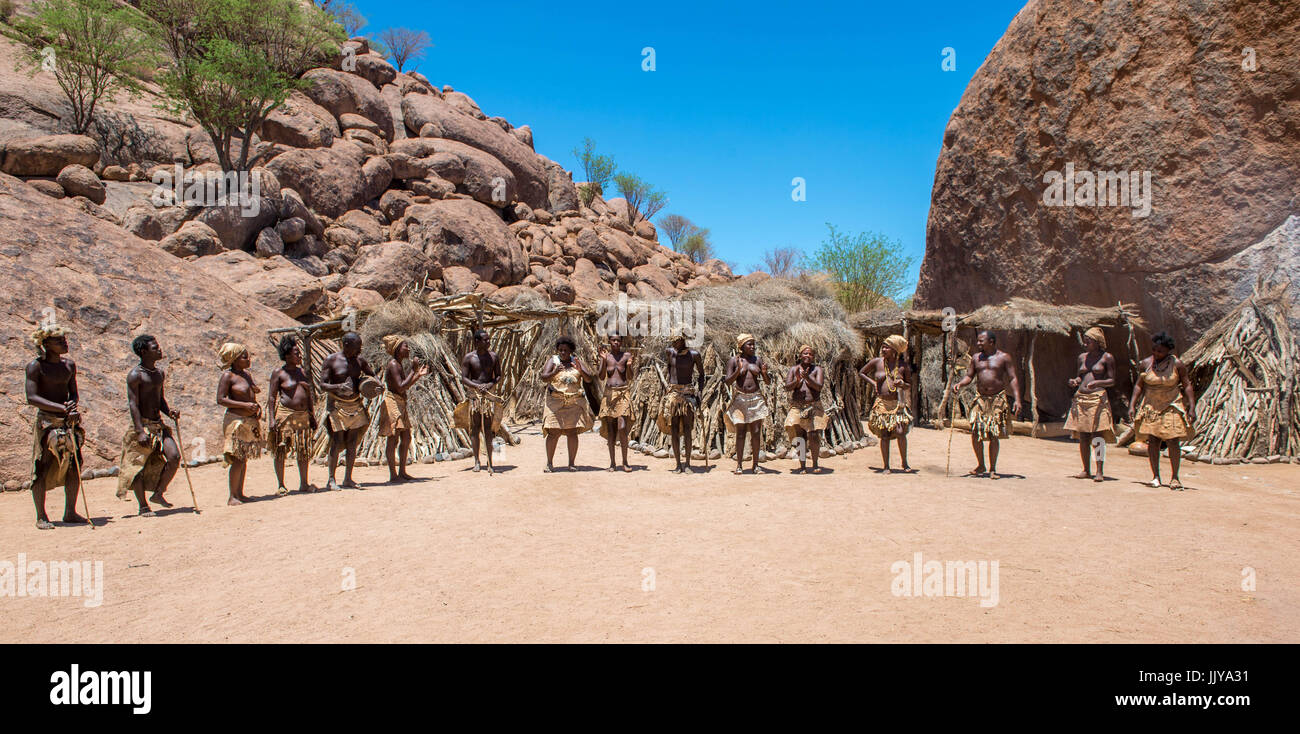 Damaran peoples stand and sing in a line at the Damara Living Museum ...