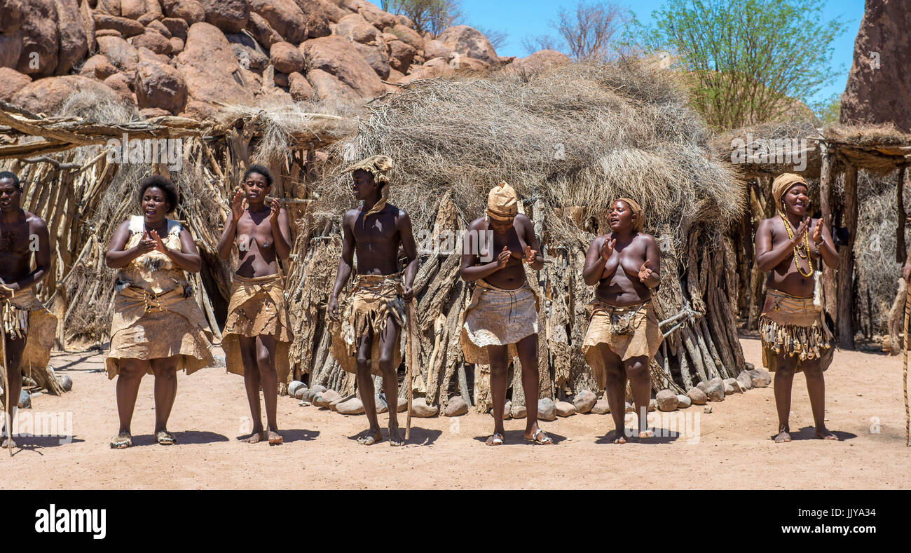 Damaran peoples stand and sing in a line at the Damara Living Museum ...