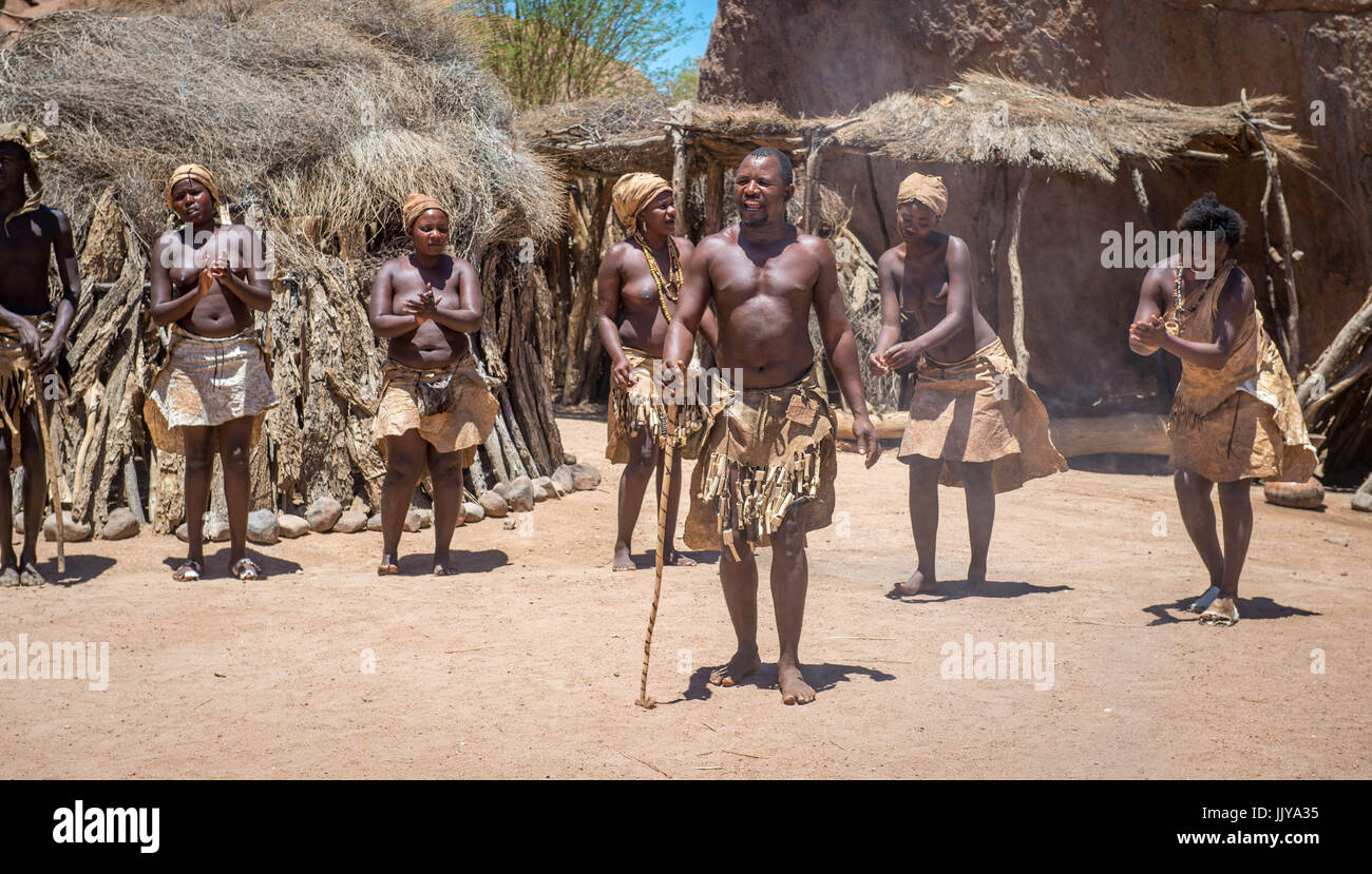 Damaran peoples stand and sing in a line at the Damara Living Museum ...