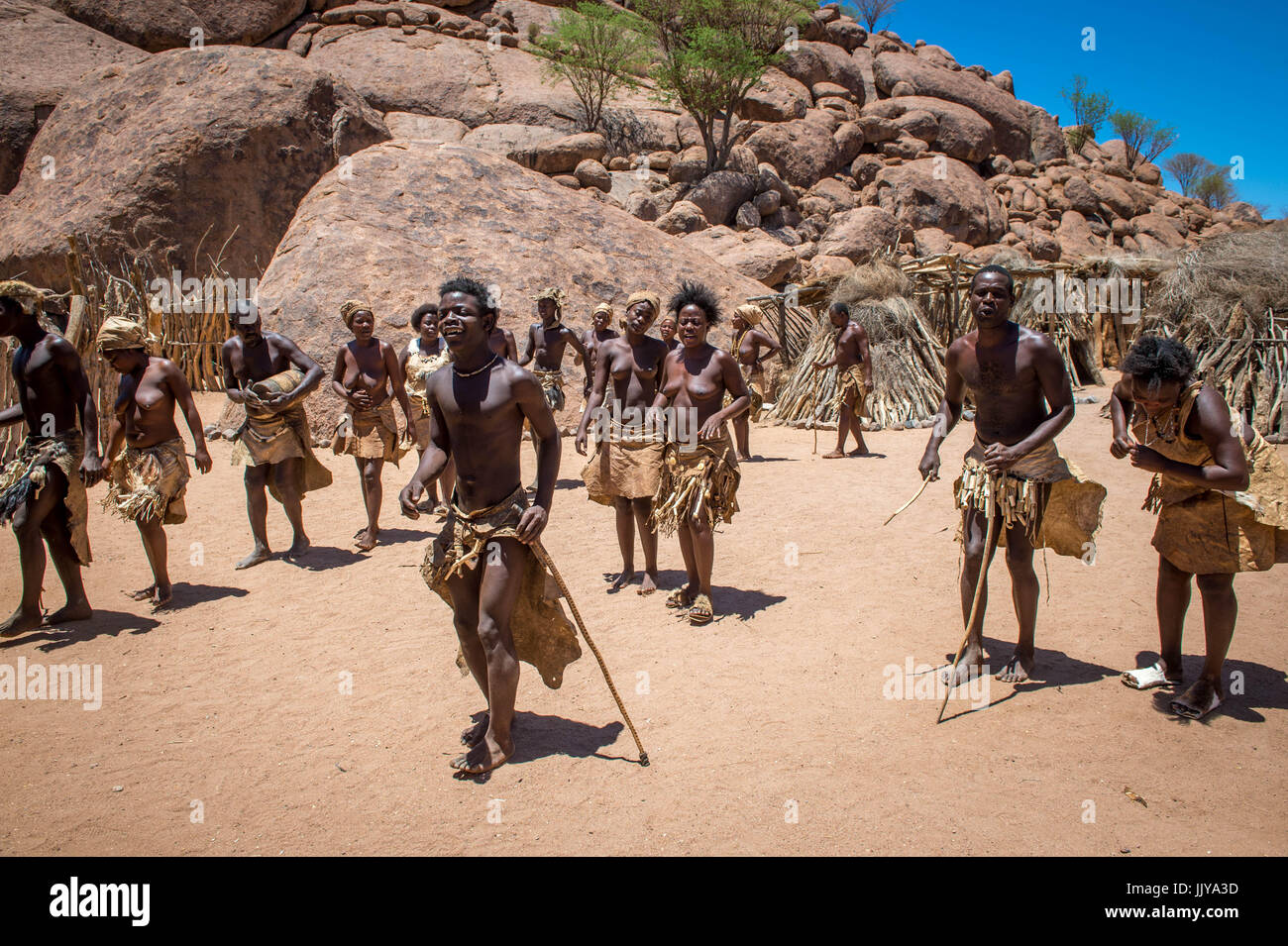 Damaran peoples stand and sing in a line at the Damara Living Museum ...