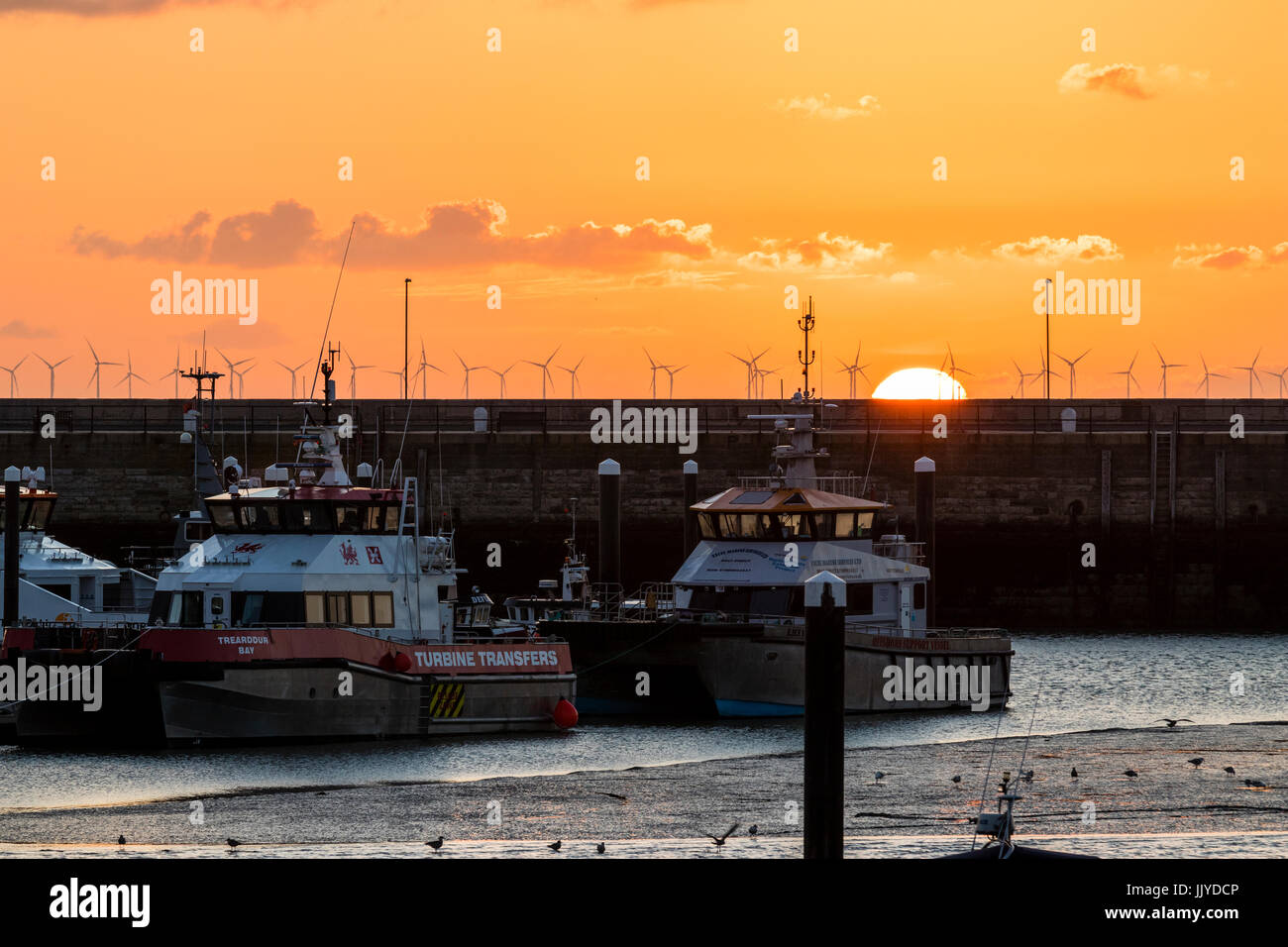Sunrise over the wall of Ramsgate Royal harbour with boats in ...