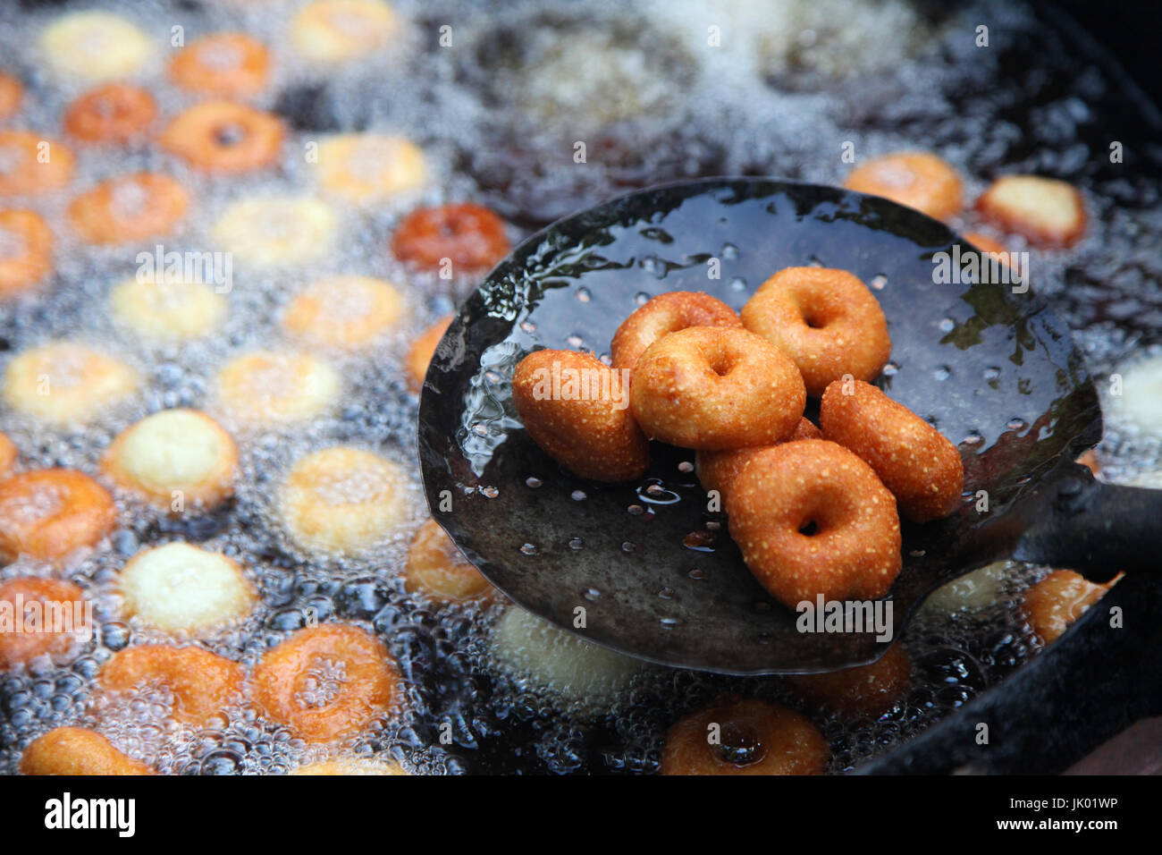 Deep frying medu vada in the pan. Medu Vada is a savoury snack from ...