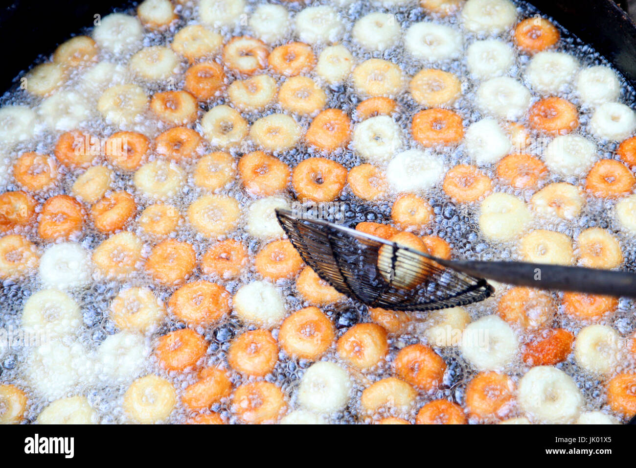Deep frying medu vada in the pan. Medu Vada is a savoury snack from ...