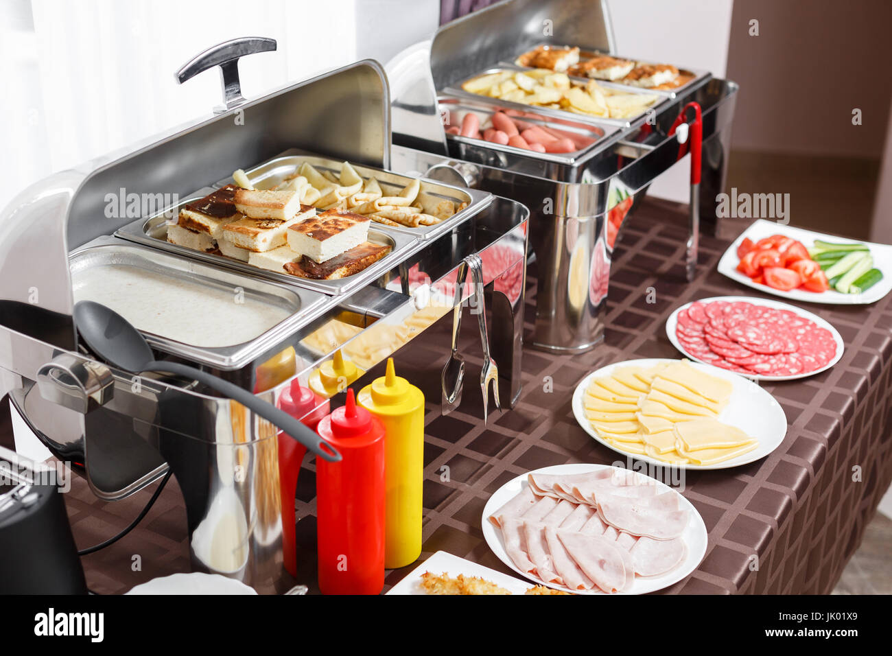 Breakfast at the hotel. Buffet Table with dishware waiting for guests ...