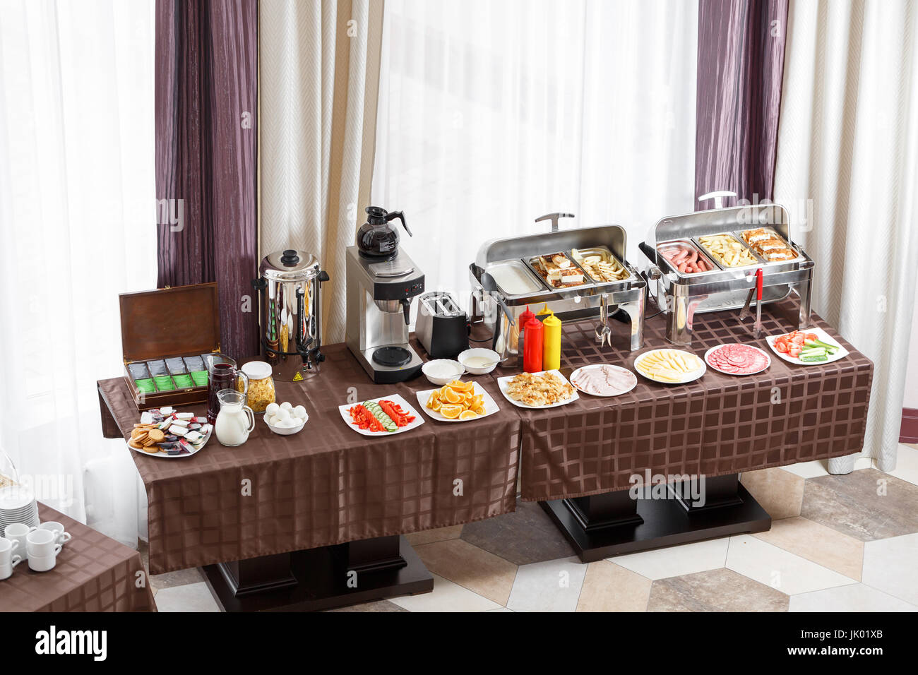Breakfast at the hotel. Buffet Table with dishware waiting for guests ...