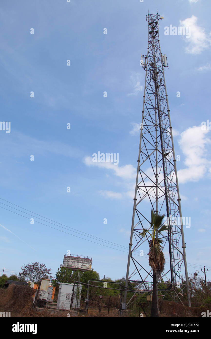 Mobile phone communication tower transmission signal with blue sky and ...