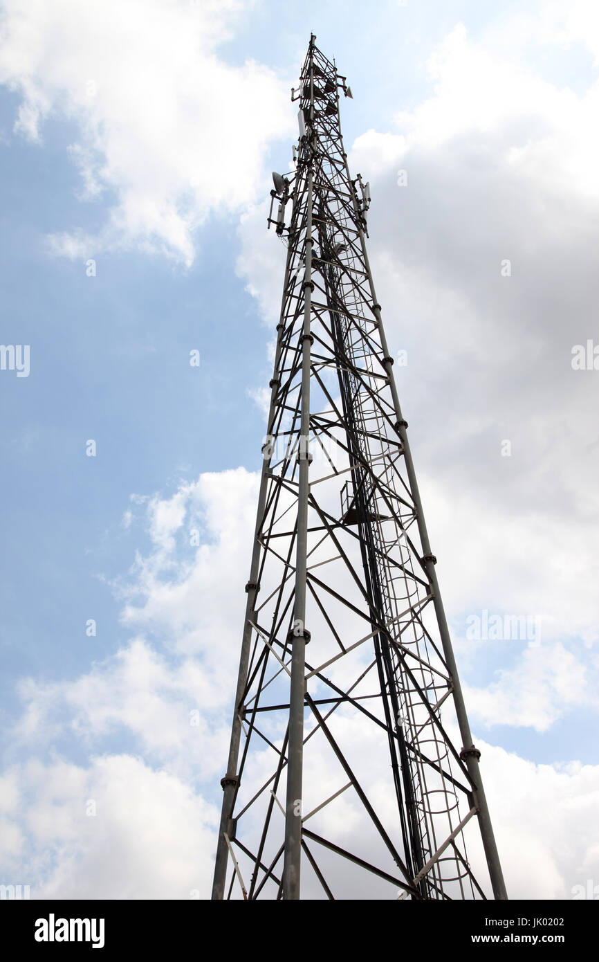 Mobile phone communication tower transmission signal with blue sky and ...