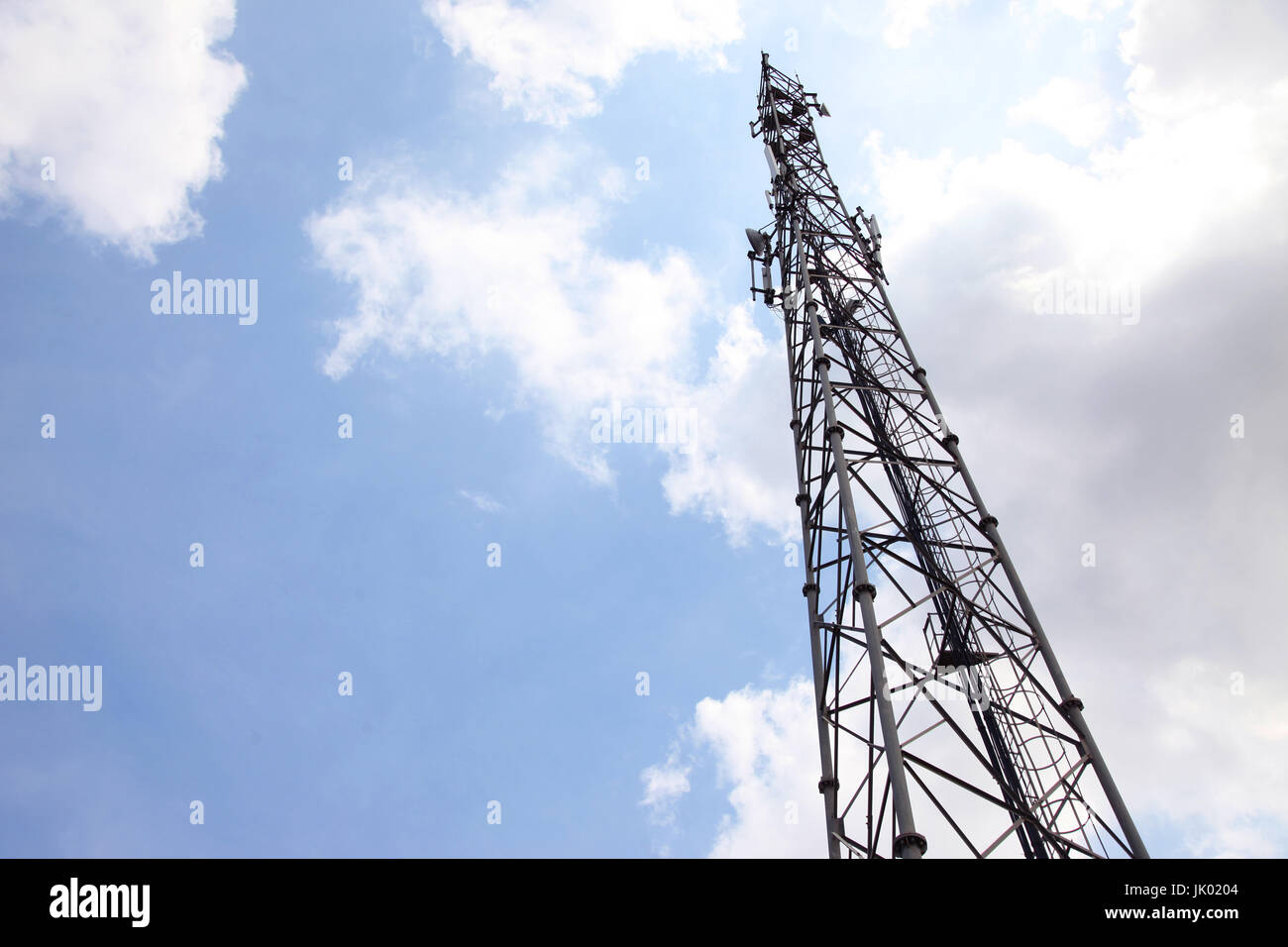 Mobile phone communication tower transmission signal with blue sky and ...