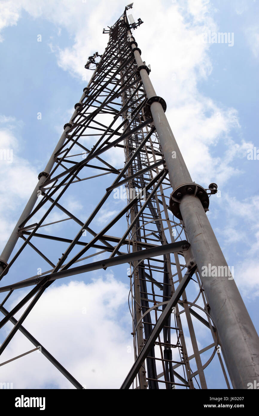 Mobile phone communication tower transmission signal with blue sky and ...