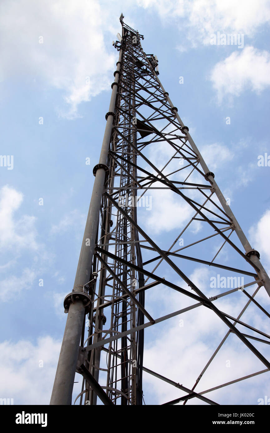 Mobile phone communication tower transmission signal with blue sky and ...