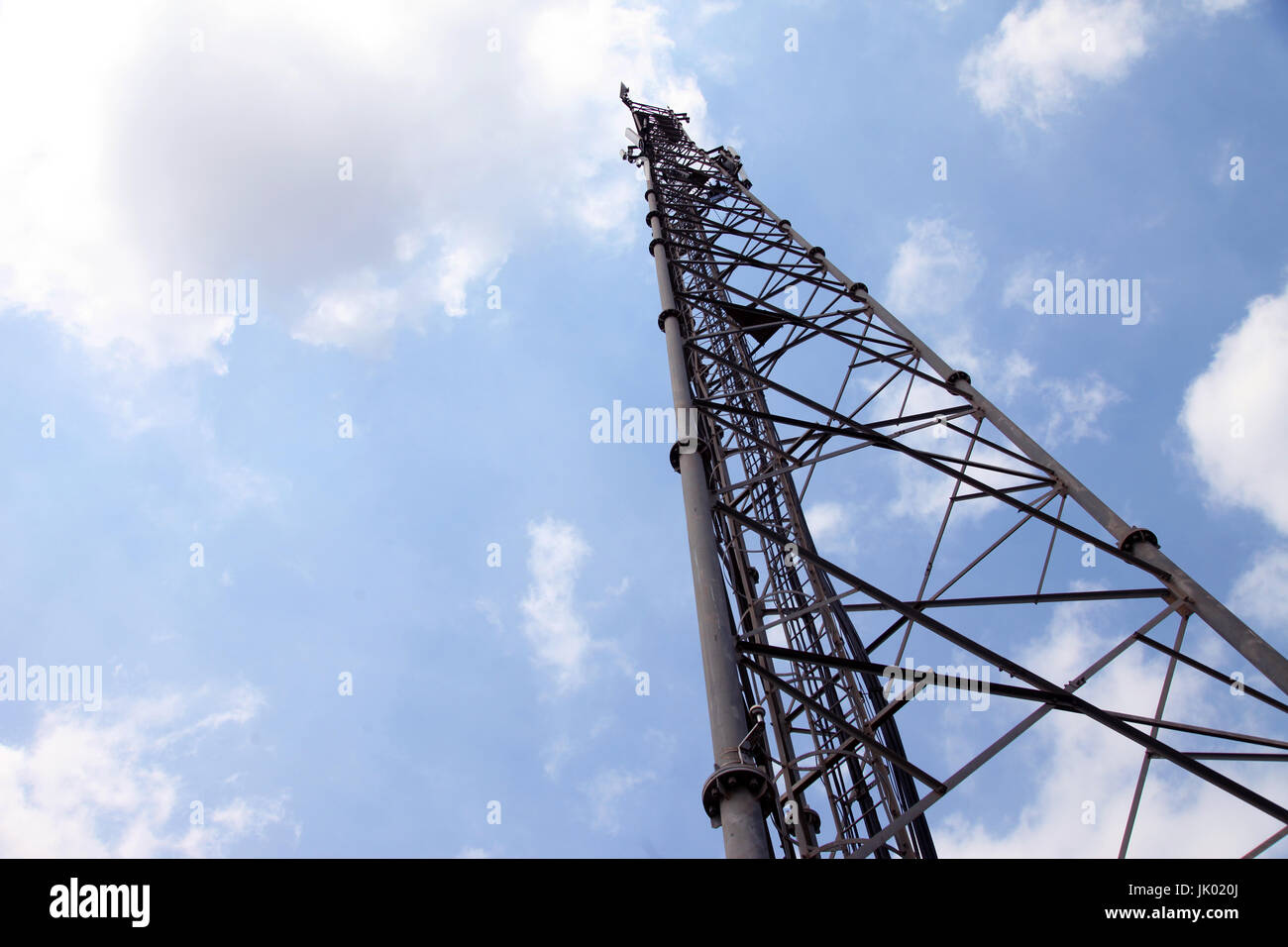 Mobile phone communication tower transmission signal with blue sky and ...