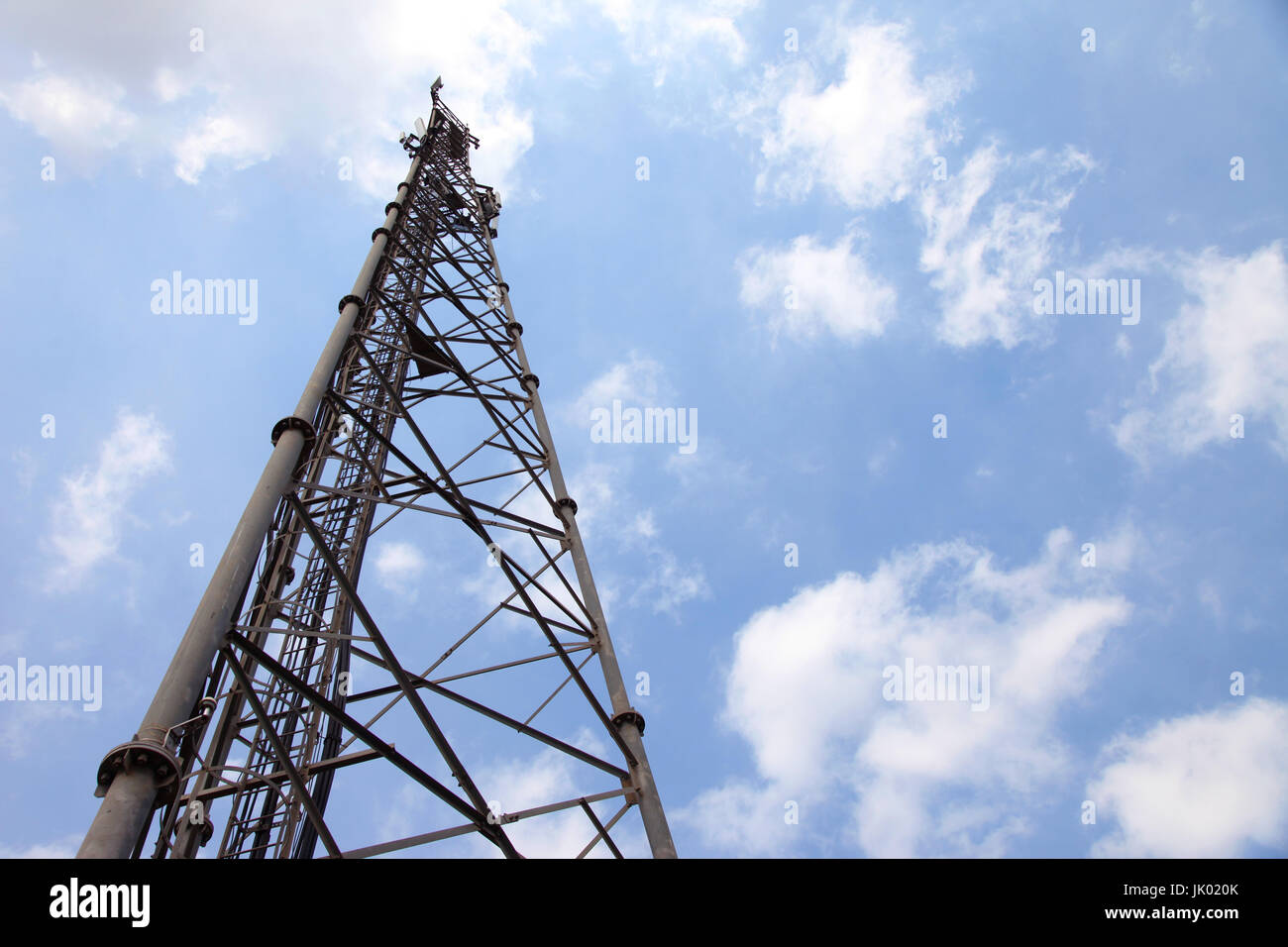 Mobile phone communication tower transmission signal with blue sky and ...