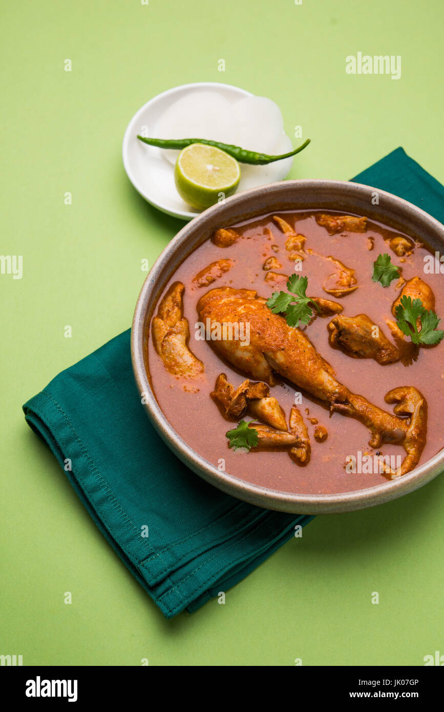 Indian spicy Chicken curry or masala chicken with prominent leg piece ...