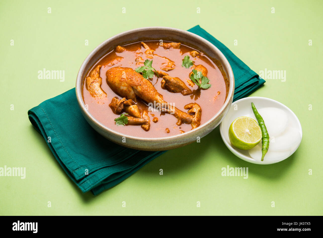 Indian spicy Chicken curry or masala chicken with prominent leg piece ...