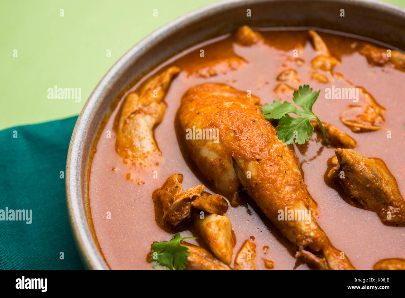 Indian spicy Chicken curry or masala chicken with prominent leg piece ...