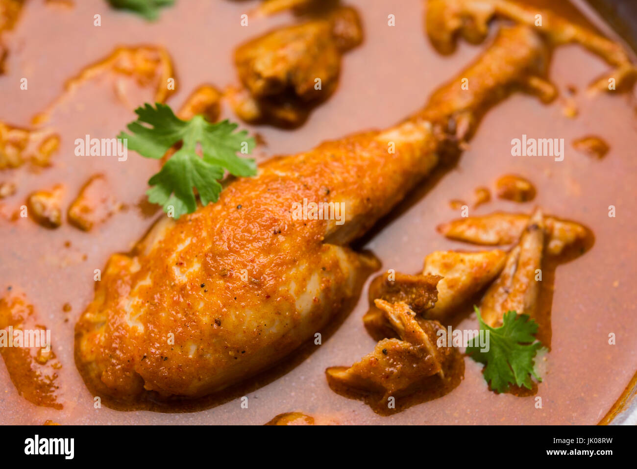Indian spicy Chicken curry or masala chicken with prominent leg piece ...