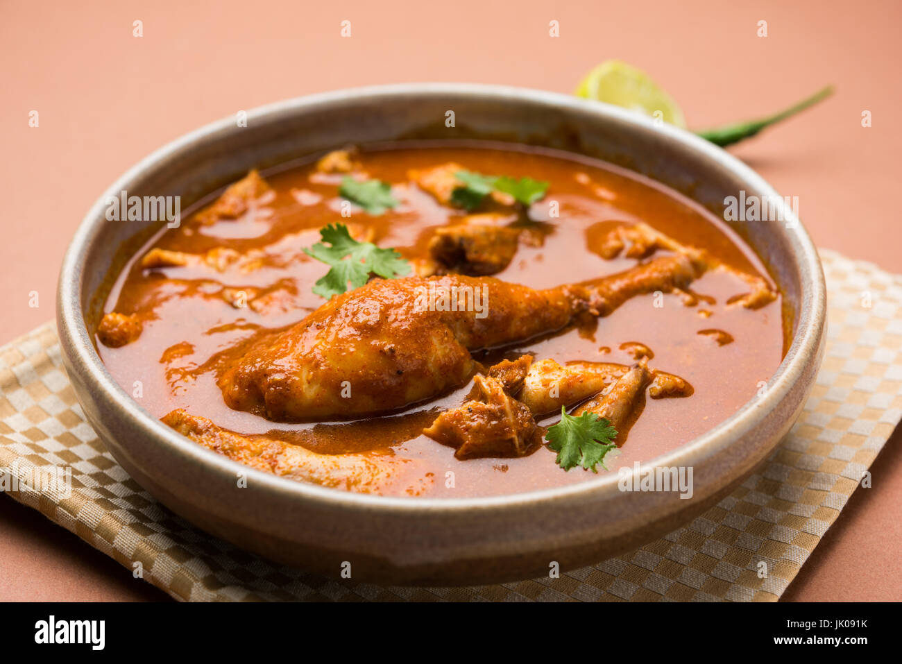 Indian spicy Chicken curry or masala chicken with prominent leg piece ...