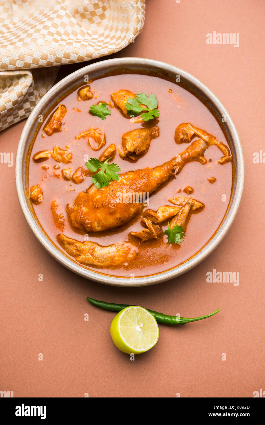 Indian spicy Chicken curry or masala chicken with prominent leg piece ...