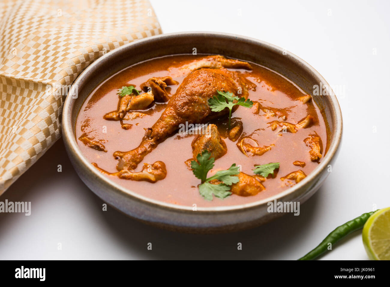Indian spicy Chicken curry or masala chicken with prominent leg piece ...