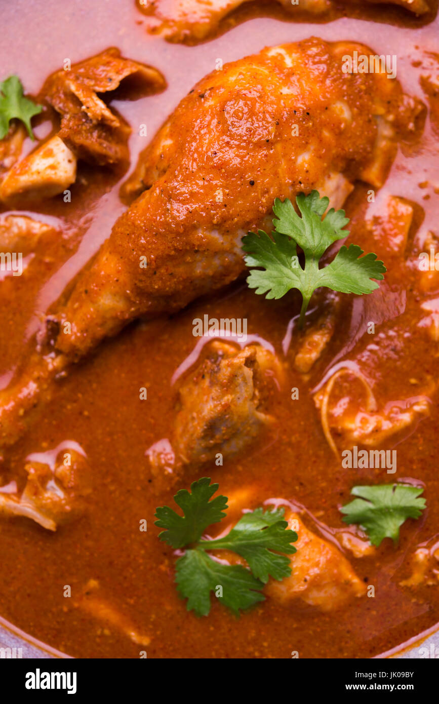 Indian spicy Chicken curry or masala chicken with prominent leg piece ...