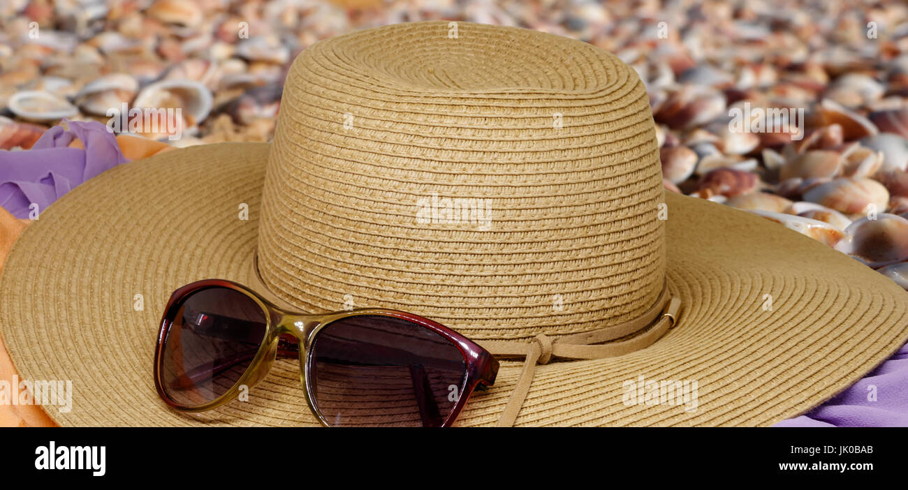 Hat from the sun with sunglasses on it Stock Photo - Alamy