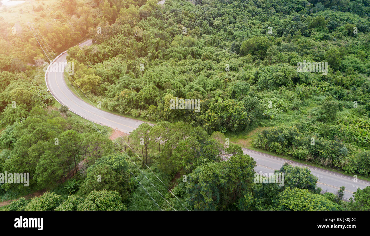 Aerial scene from drone: road in the mountains surrounded by a green ...