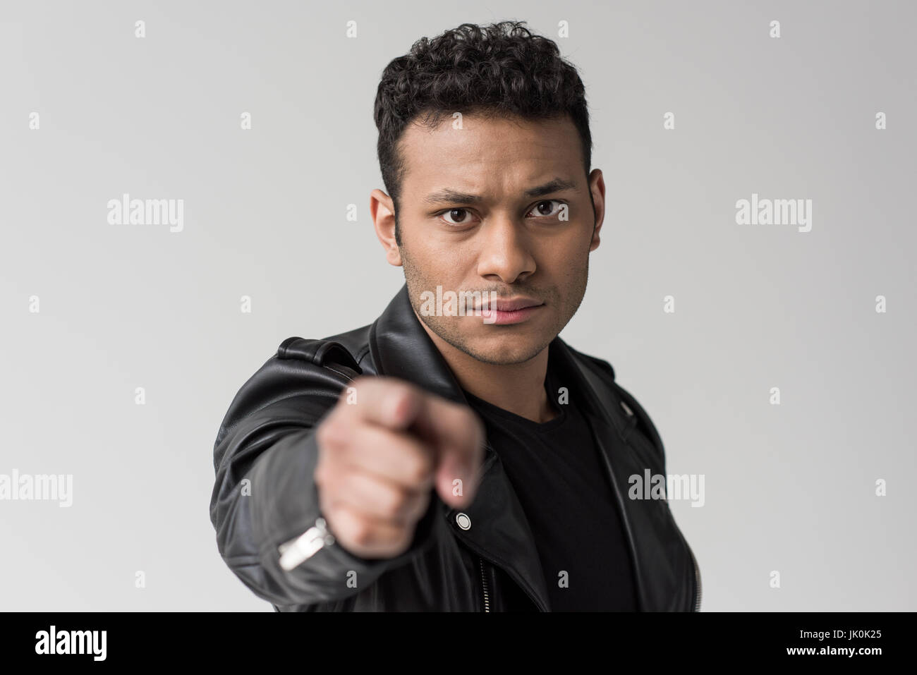 portrait of serious african american man pointing isolated on grey ...