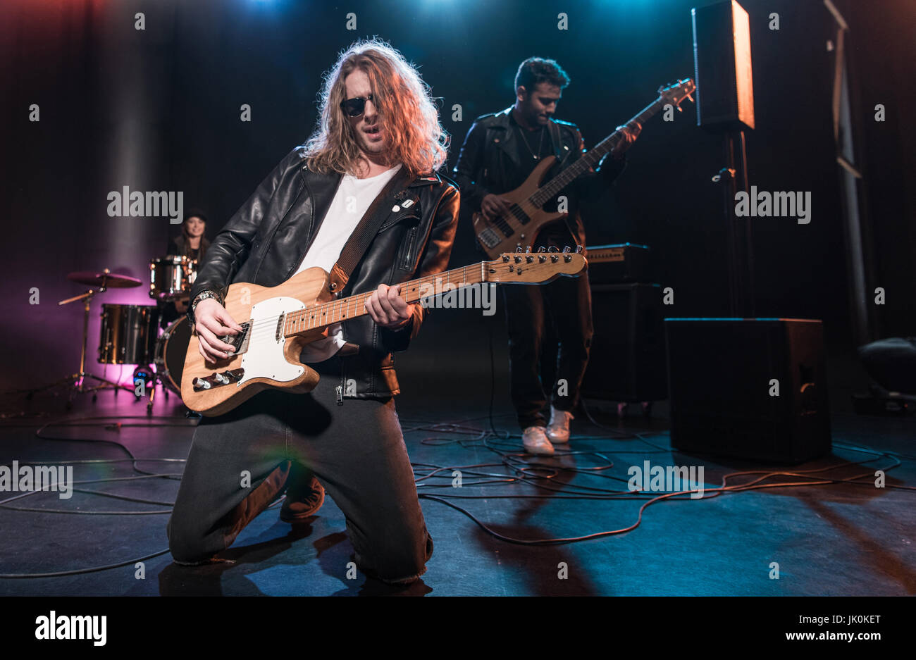 Electric guitar players performing hard rock music on stage Stock Photo ...