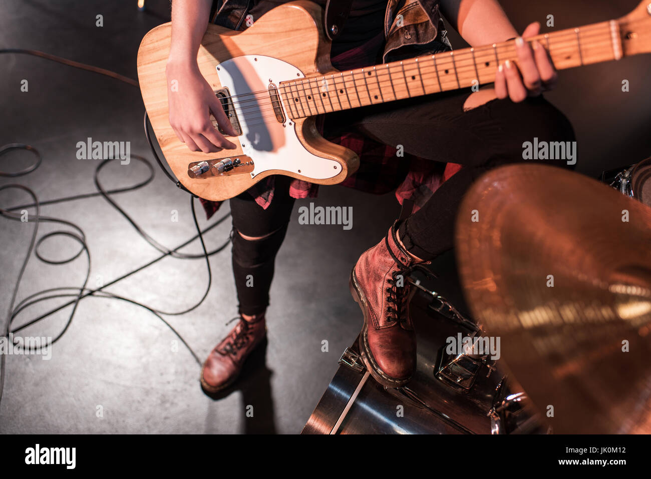 Cropped shot of rock and roll girl playing bass guitar on stage Stock ...