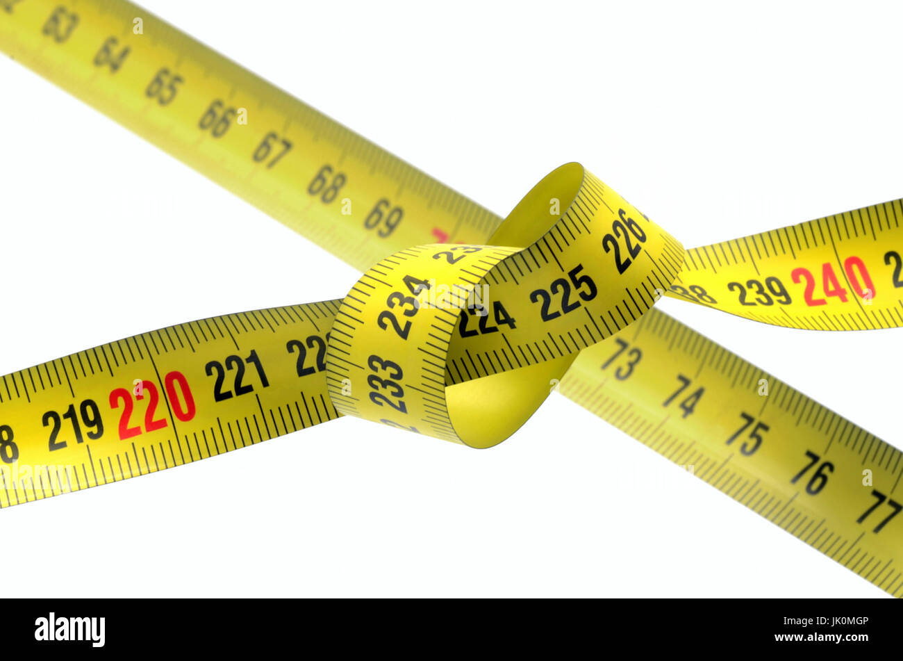 tangled tape measure on white background Stock Photo - Alamy