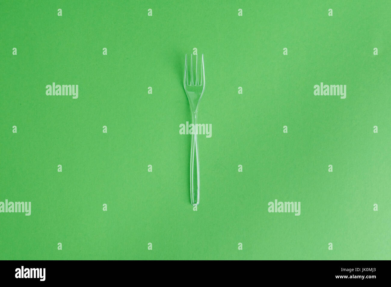 top view of transparent plastic fork isolated on green Stock Photo - Alamy