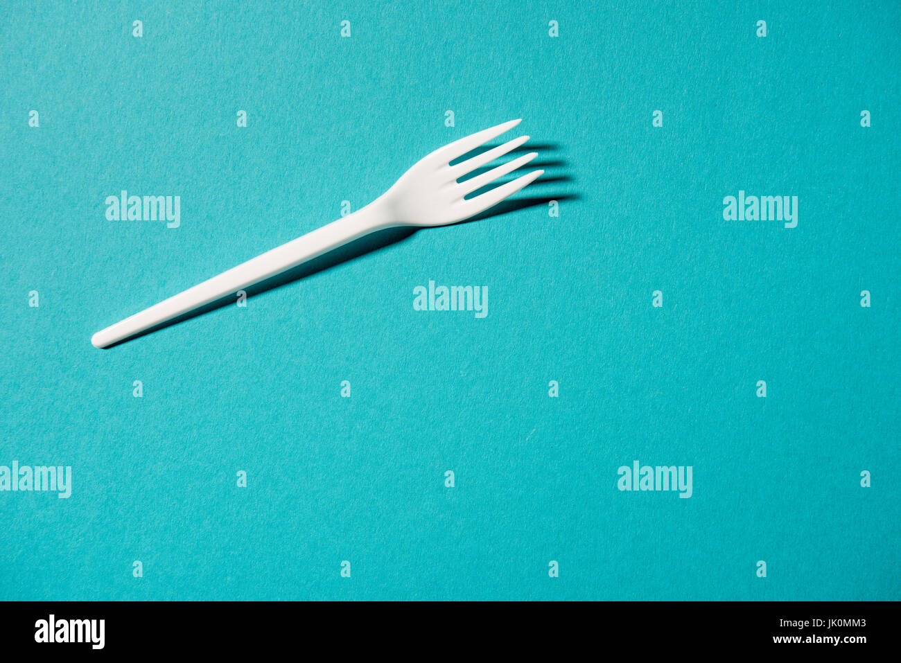 top view of white plastic fork isolated on blue Stock Photo - Alamy