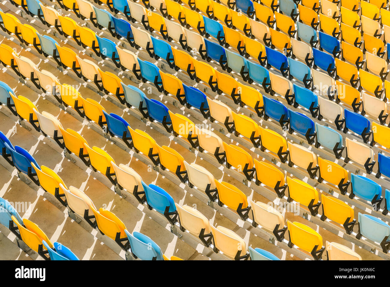 elevated view of rows of yellow and blue stadium seats background Stock ...
